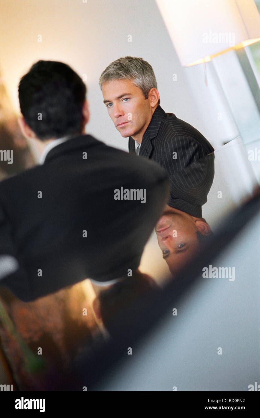 Mid adult businessman listening hi-res stock photography and images - Alamy