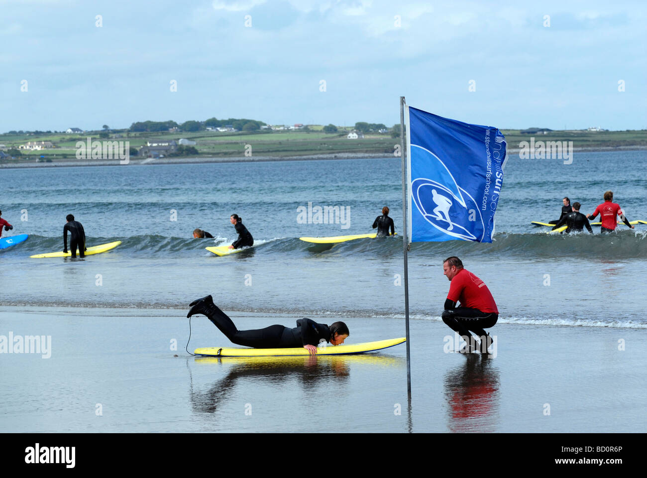 Young Irish people learning to surf with a surf training school Co ...