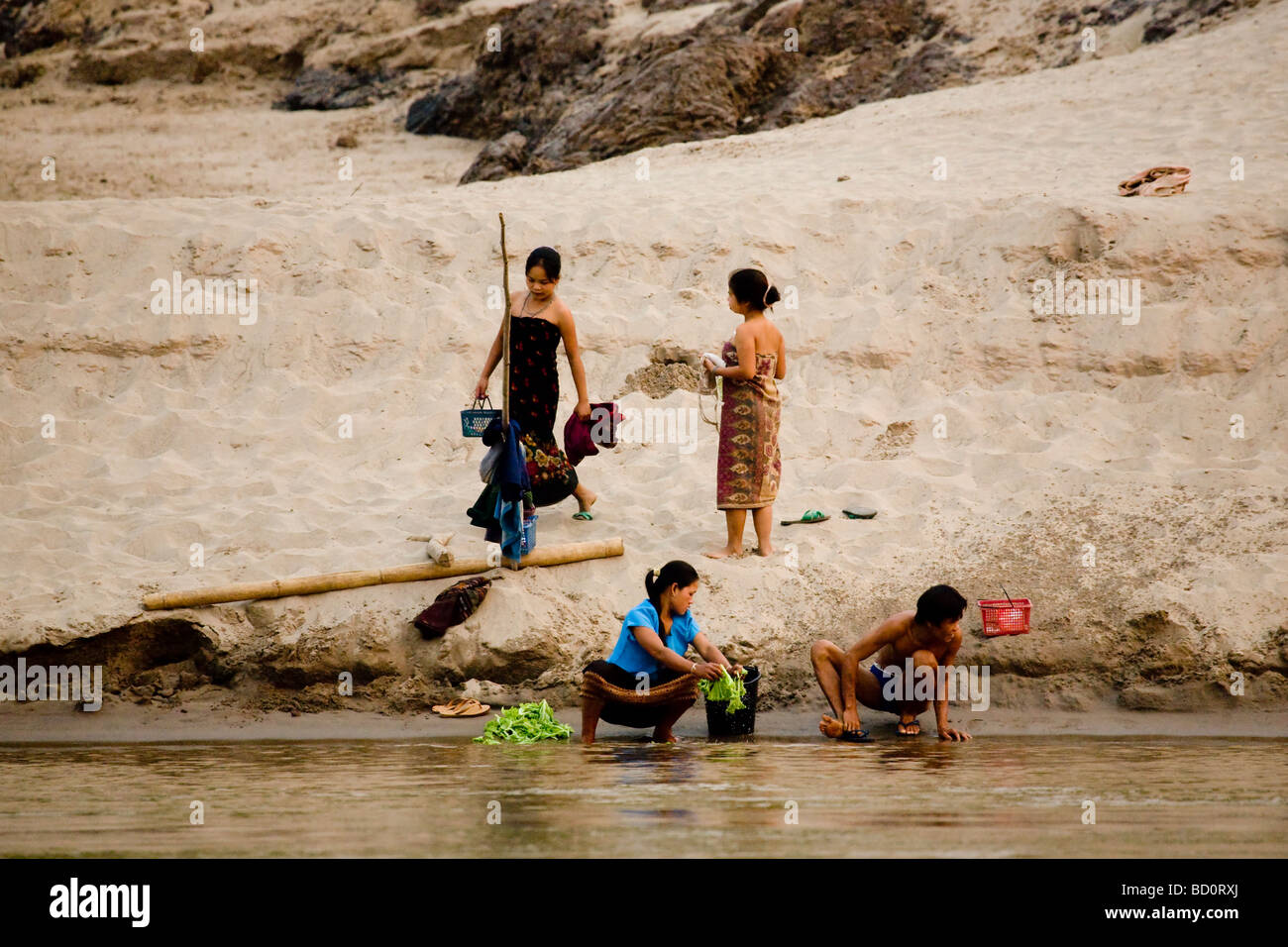 Lao people washing on the banks of the Mekong River, Laos Stock Photo ...