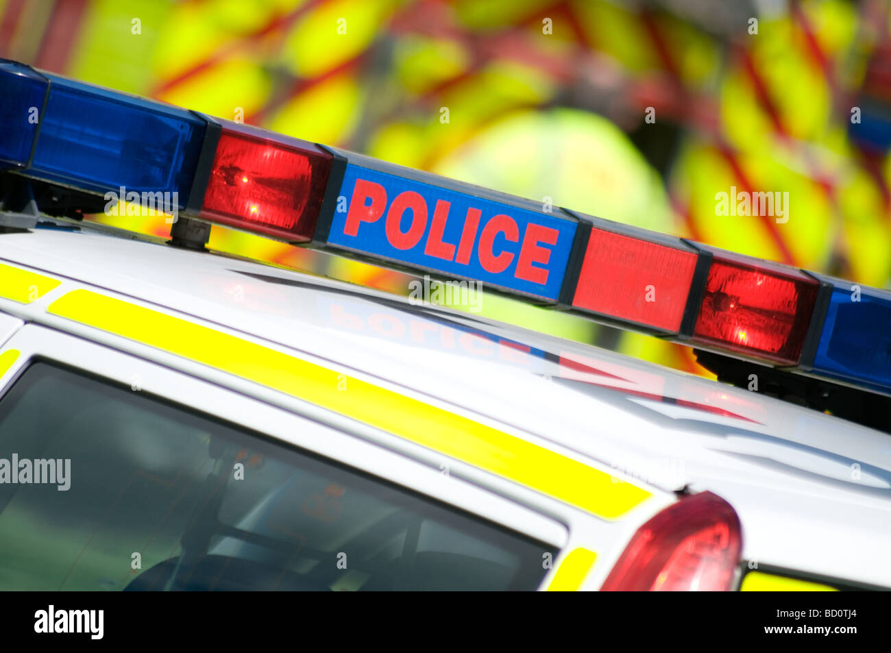 Crop of police lights on a traffic car with the back of a fire engine ...