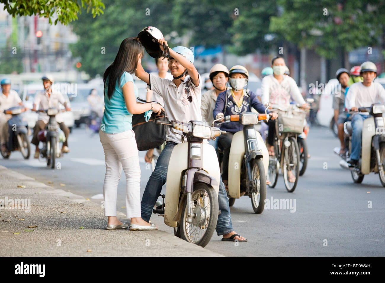People riding scooters/mopeds in Vietnam in Ho Chi Minh City Stock ...