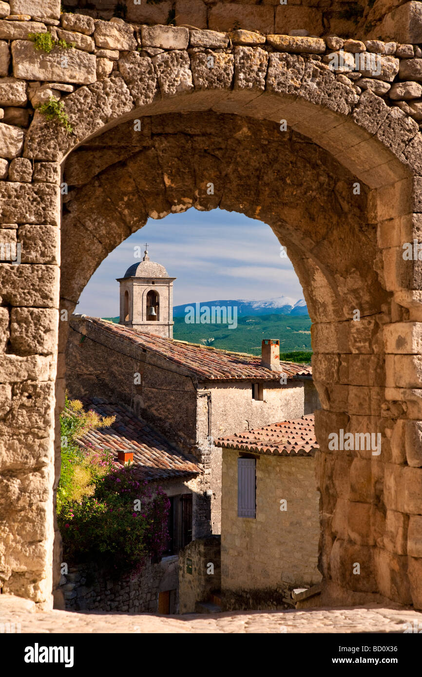 Church bell-tower through Medieval stone gate with Mont Ventoux beyond ...
