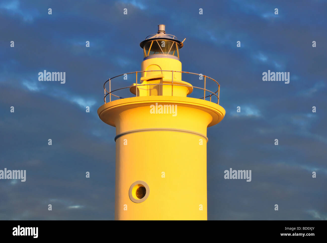 lighthouse isolated against a cloudy sky by sunset colors Stock Photo ...
