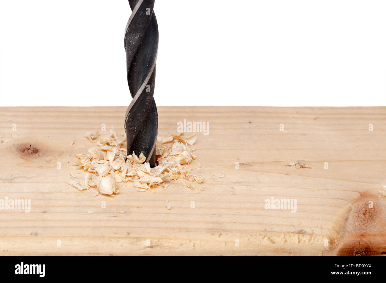 A horizontal close up of a hole being bored into wood with a drill bit ...