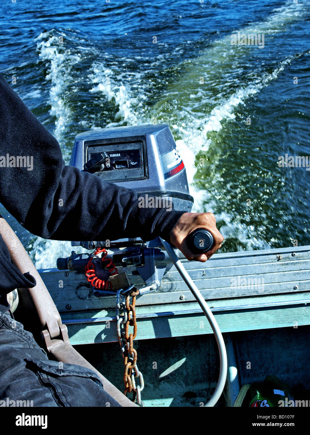 motor motorboat in action with just the arm showing guiding the boat ...