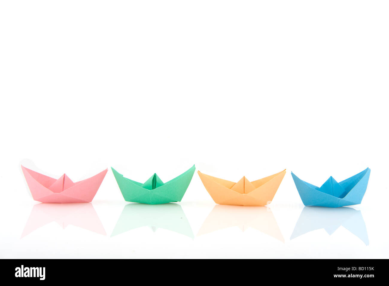Paper boats in different colors in a row Stock Photo - Alamy