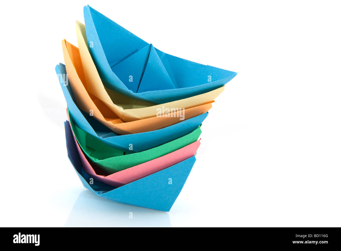 Stacked paper boats in different colors over white Stock Photo - Alamy