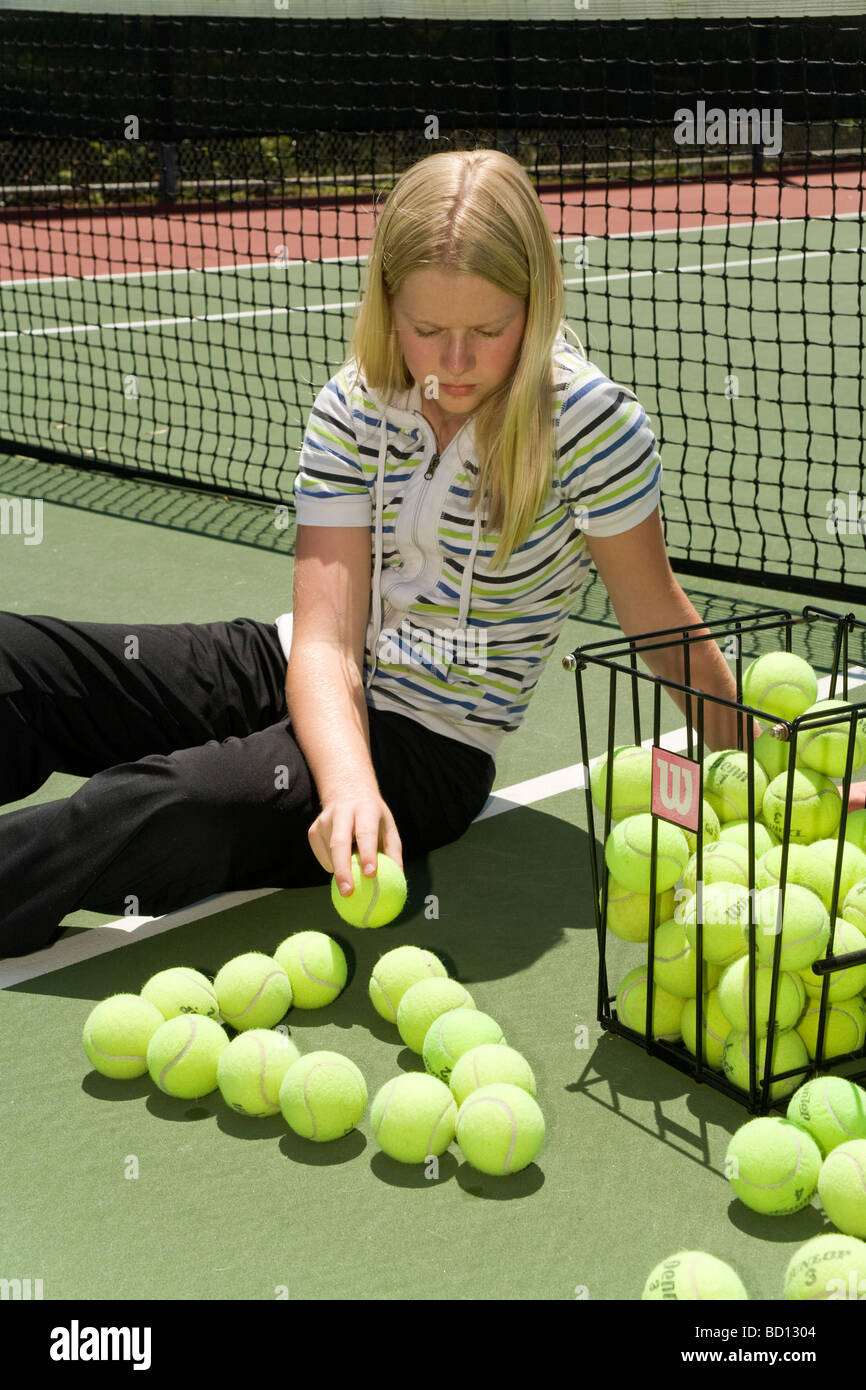 6th grade girl building an isosceles triangle of tennis balls. MR Stock ...