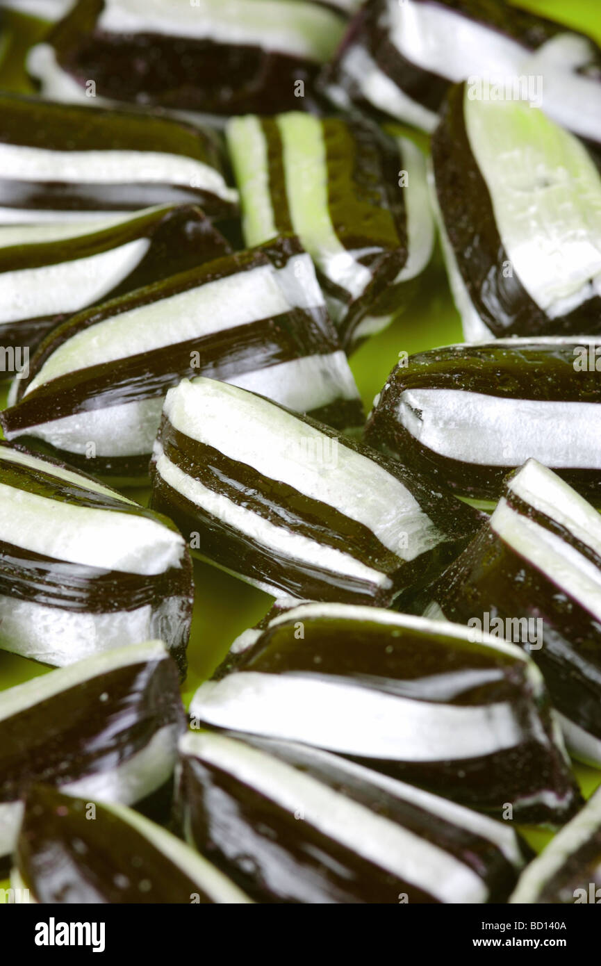 Humbugs isolated against a green background Stock Photo - Alamy