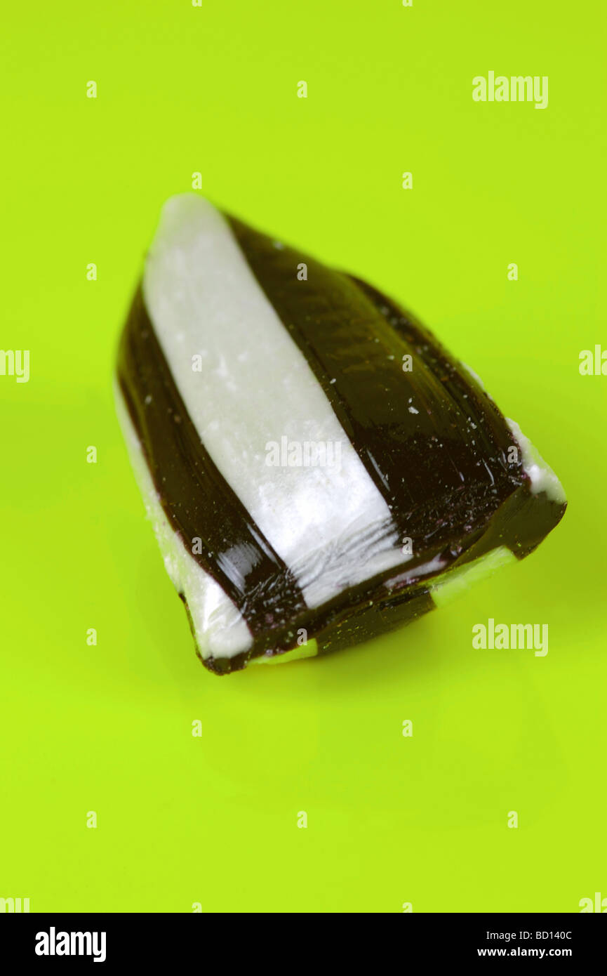Humbugs isolated against a green background Stock Photo - Alamy