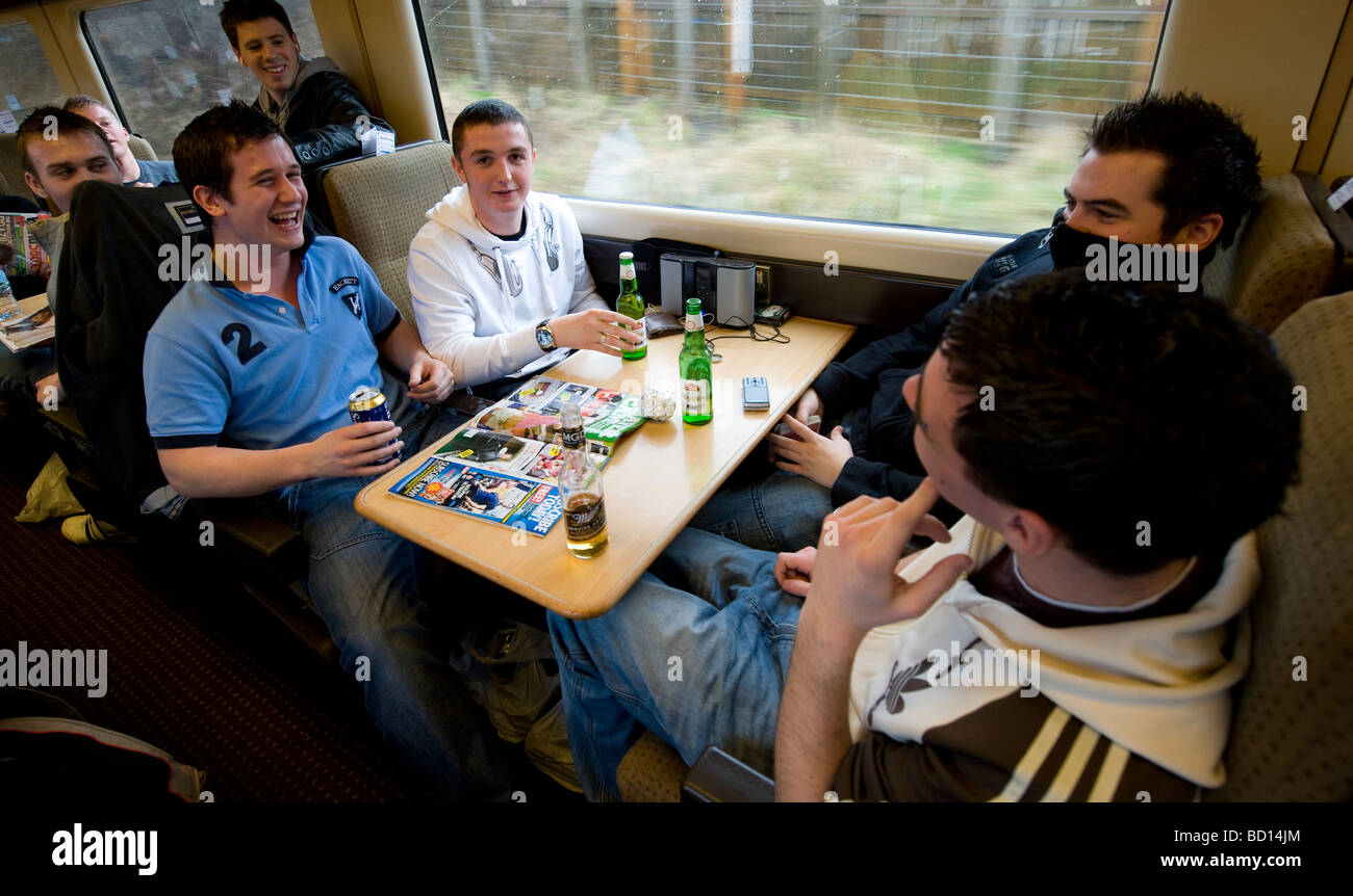Young white European males celebrating on a train journey Stock Photo ...