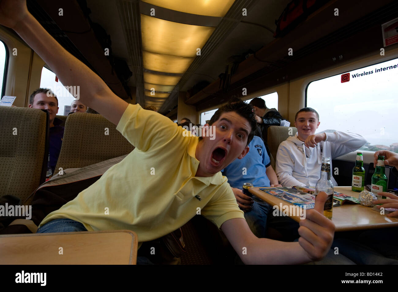 Young white European males celebrating on a train journey Stock Photo ...