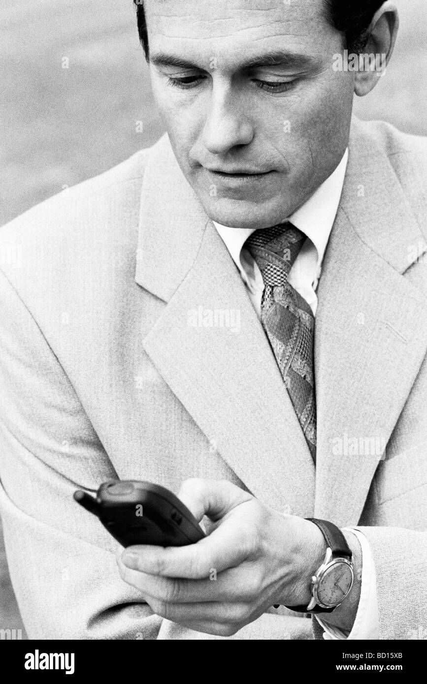 Businessman messaging on phone Black and White Stock Photos & Images ...