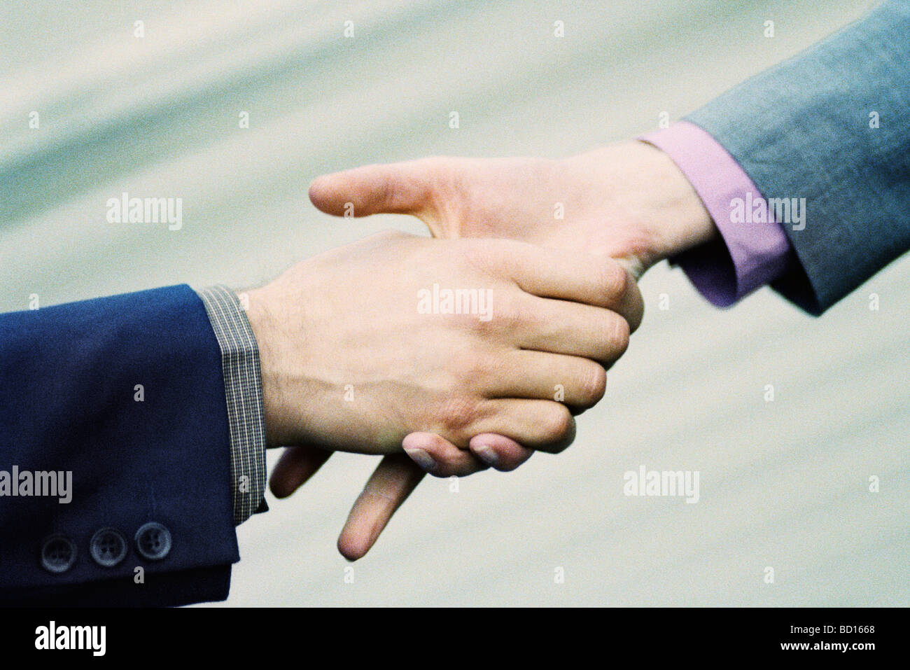 Hesitant handshake between professionals Stock Photo - Alamy
