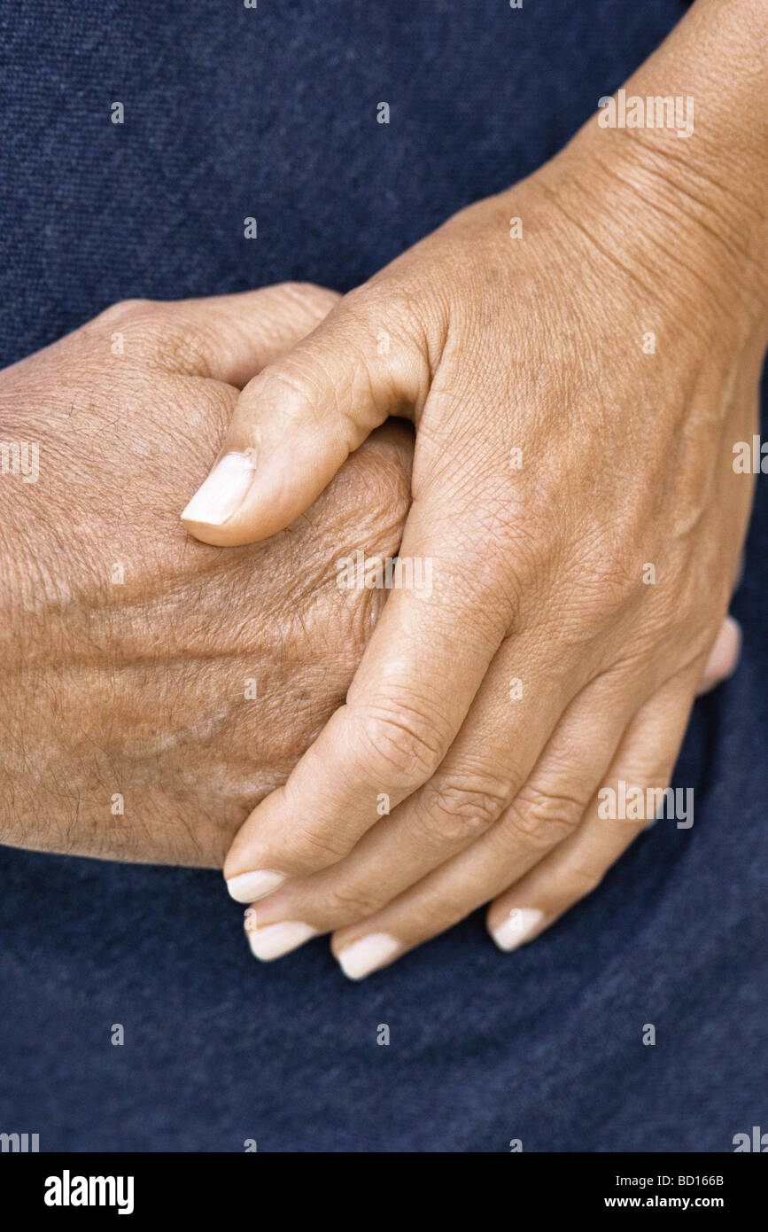 Woman's hand resting on top of man's hand, close-up Stock Photo - Alamy