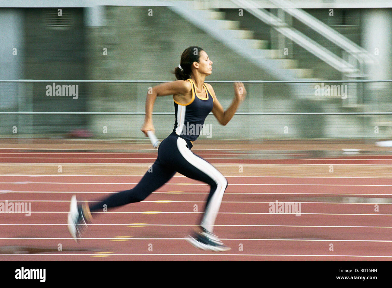 Woman running on track Stock Photo - Alamy