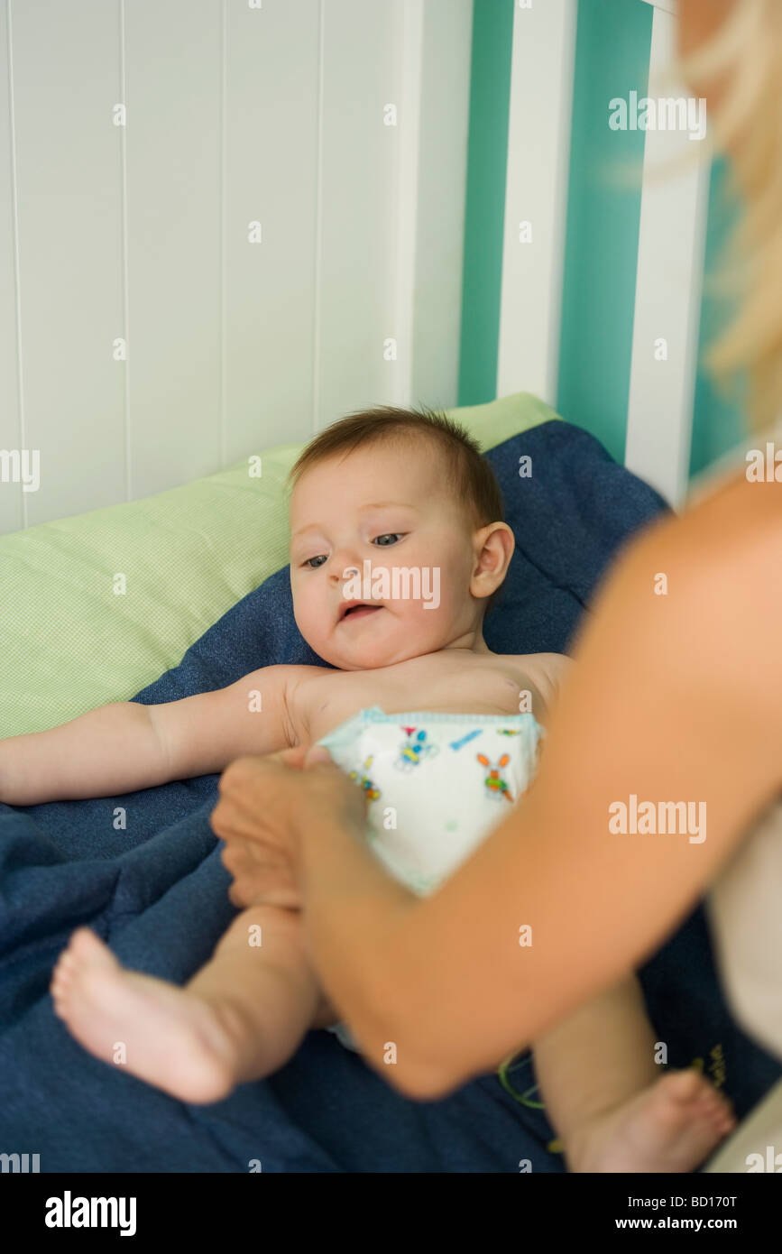Woman changing baby's diaper Stock Photo - Alamy