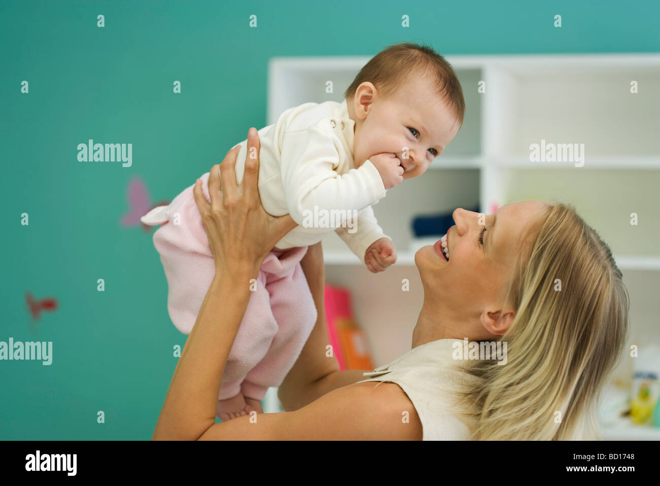 Baby laughing in mothers arms hi-res stock photography and images - Alamy