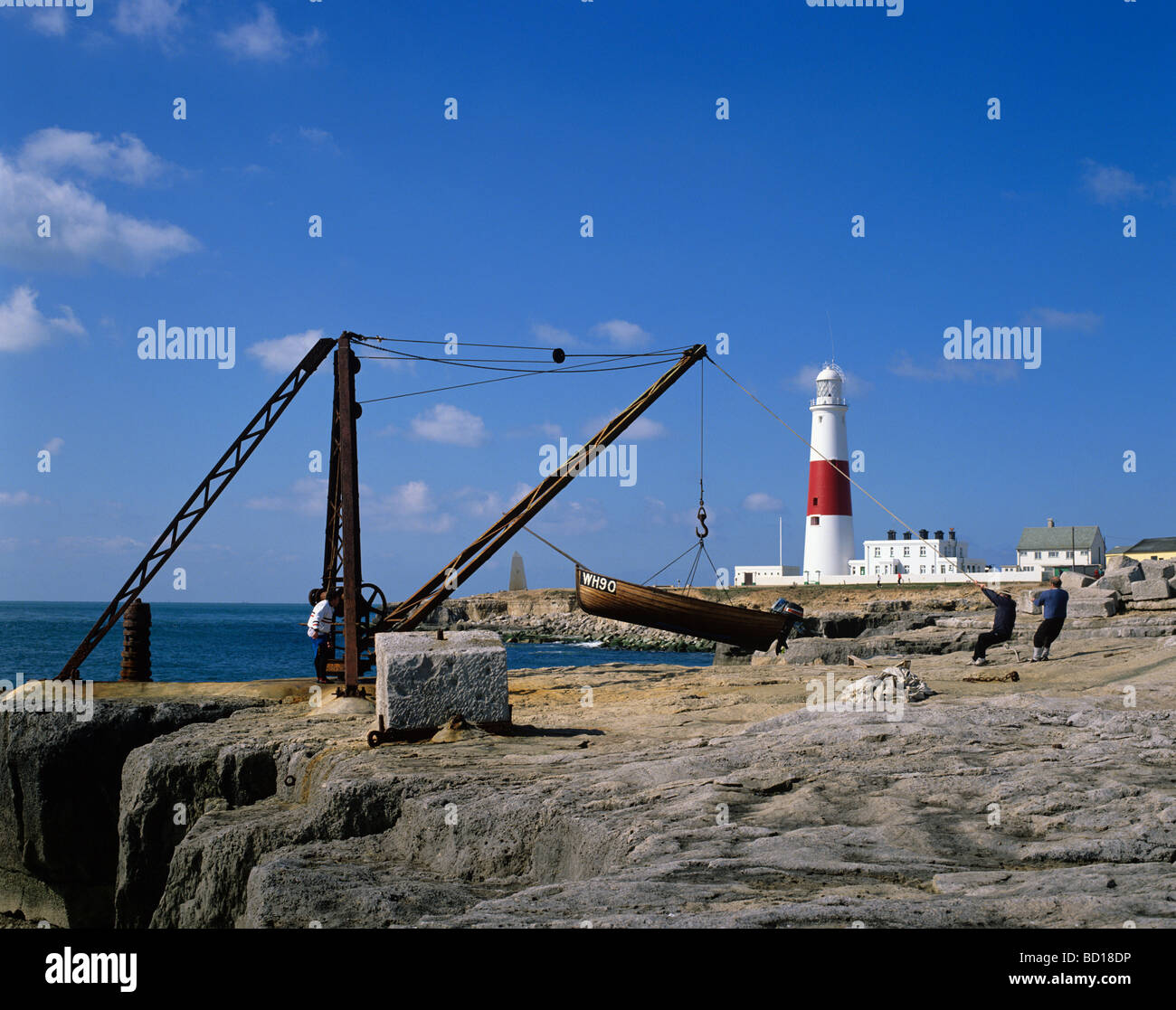 Hoisting a fishing boat out of the water by Portland Bill Lighthouse ...