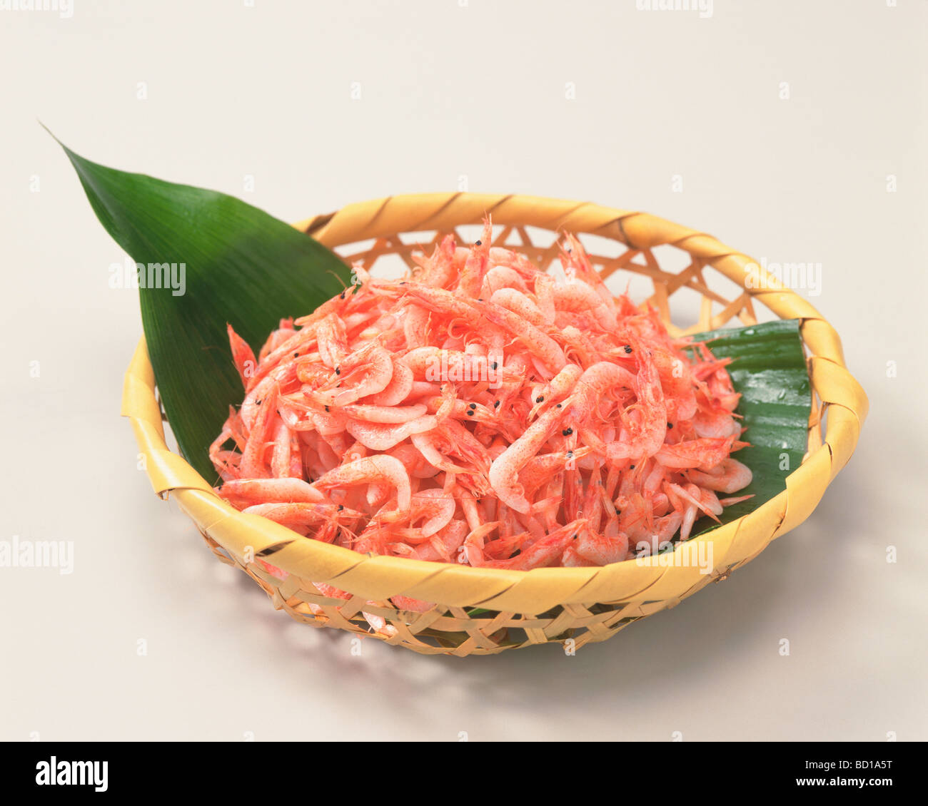 Stack of shrimps in colander white background Stock Photo - Alamy