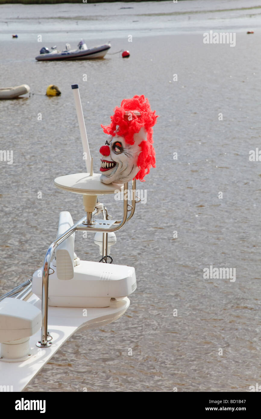 A Scary Clown mask on the radar aerials of a motor boat on the River ...