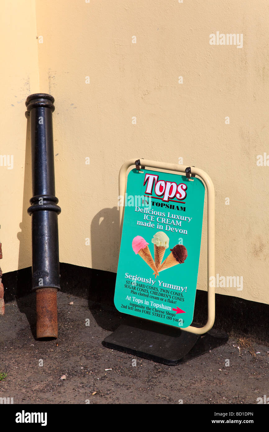 An Ice Cream sign and traffic bollard lean against a cream painted wall ...