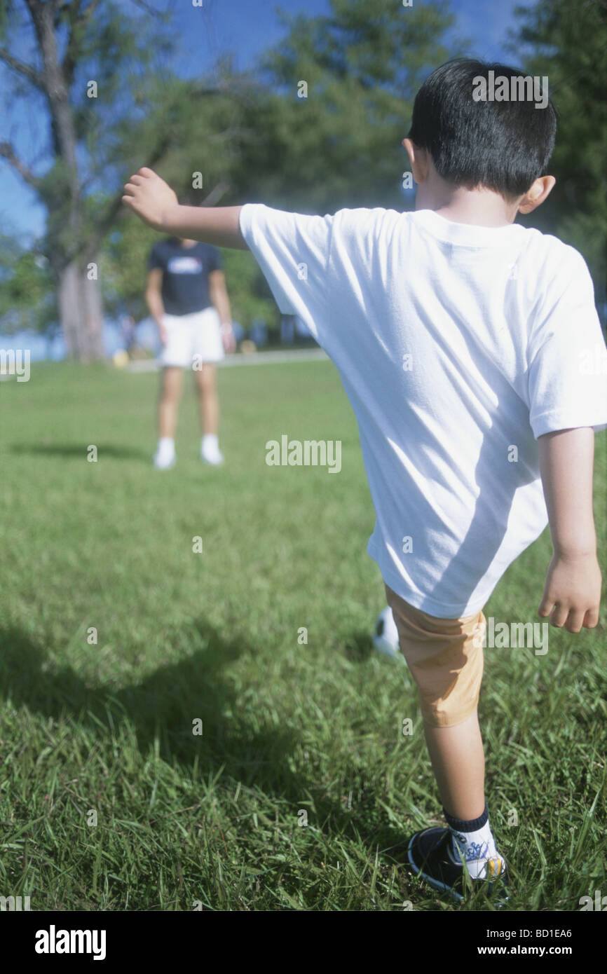 Boy kicking a soccer ball Stock Photo - Alamy