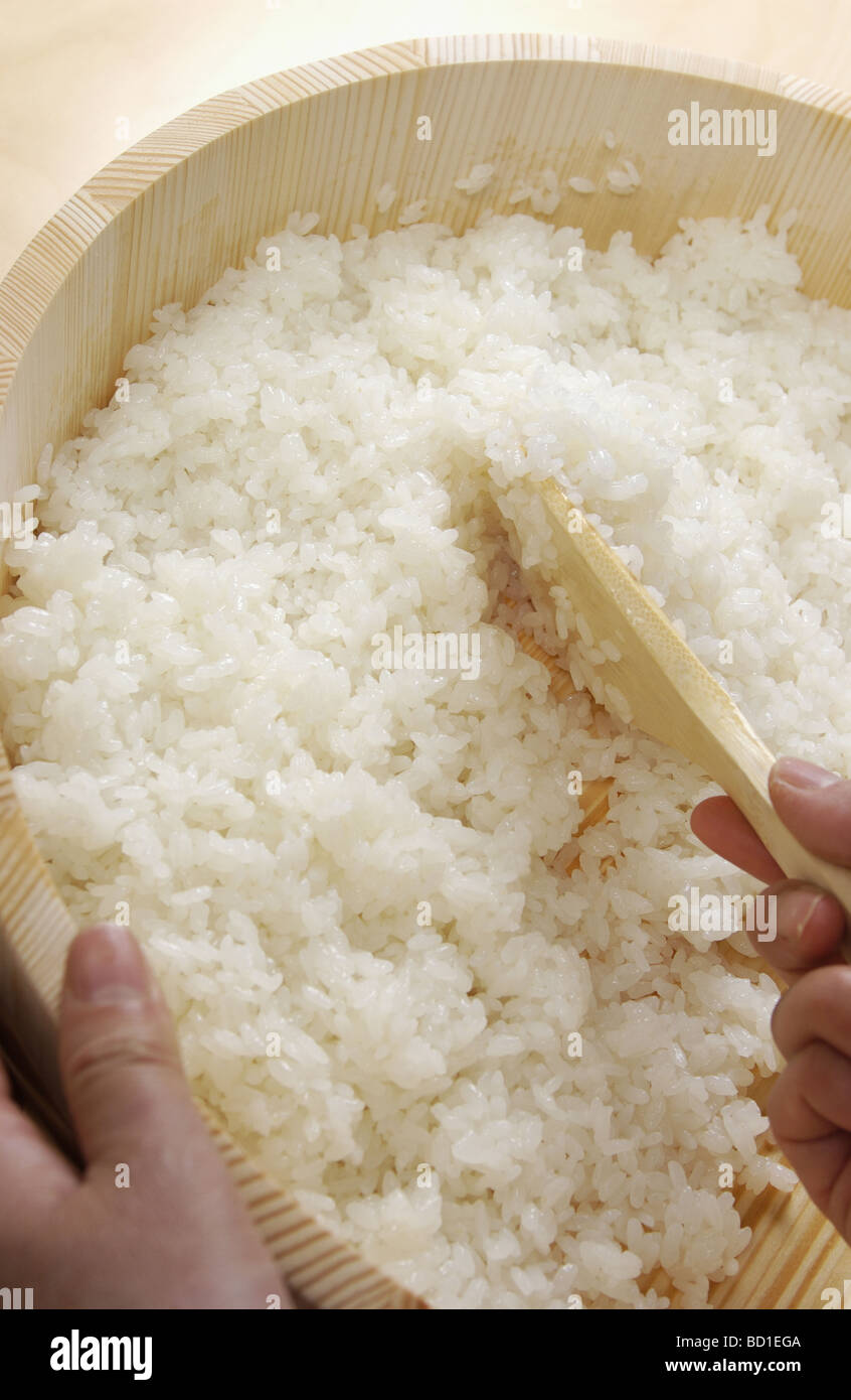 Hand scooping rice in Ohitsu Stock Photo - Alamy