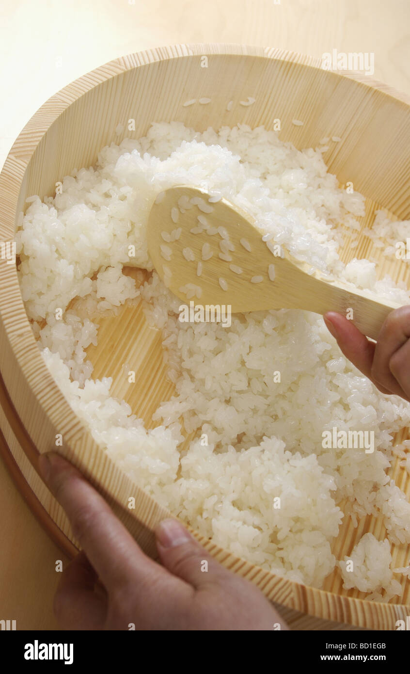 Hand scooping rice in Ohitsu Stock Photo - Alamy