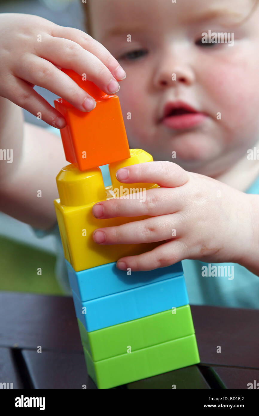 Child playing with toy bricks Stock Photo - Alamy