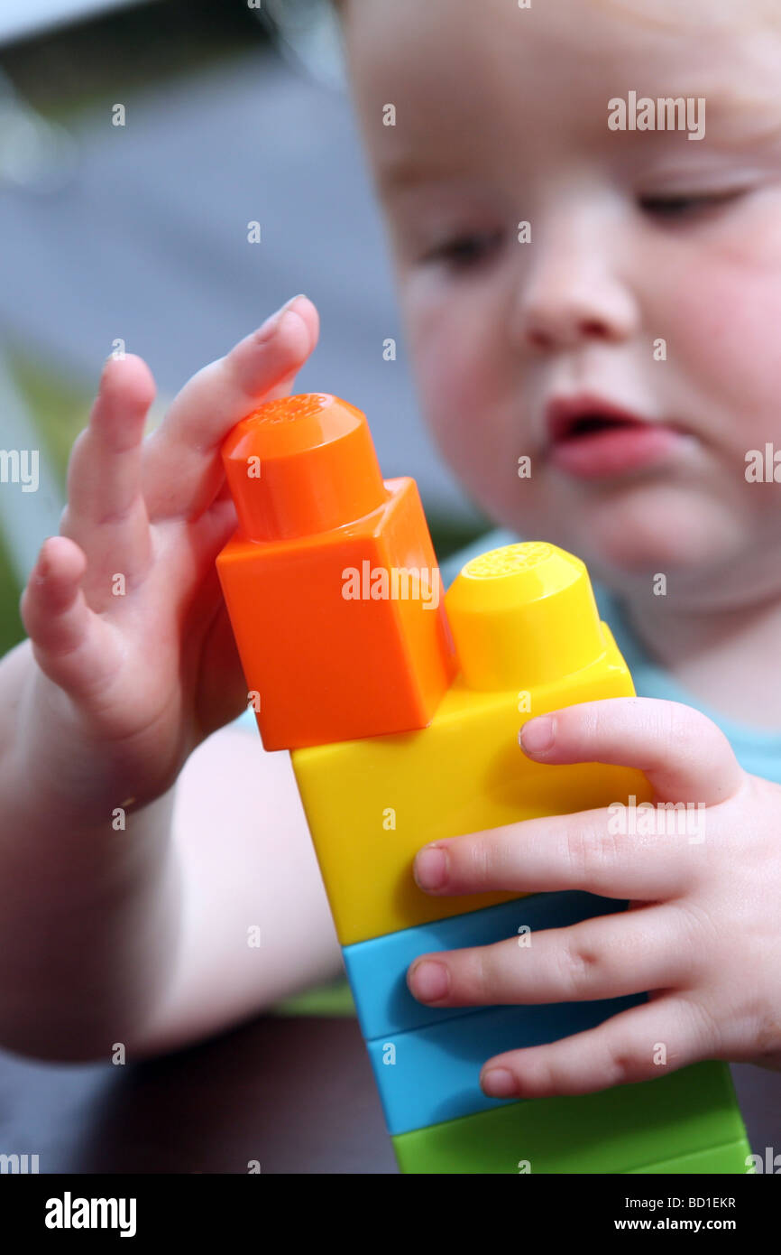 Child playing with toy bricks Stock Photo - Alamy