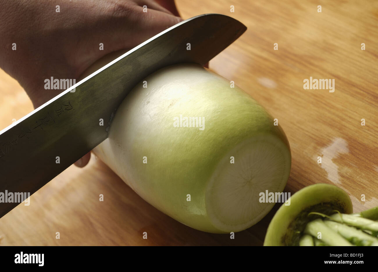 Chef cutting radish close up Stock Photo - Alamy