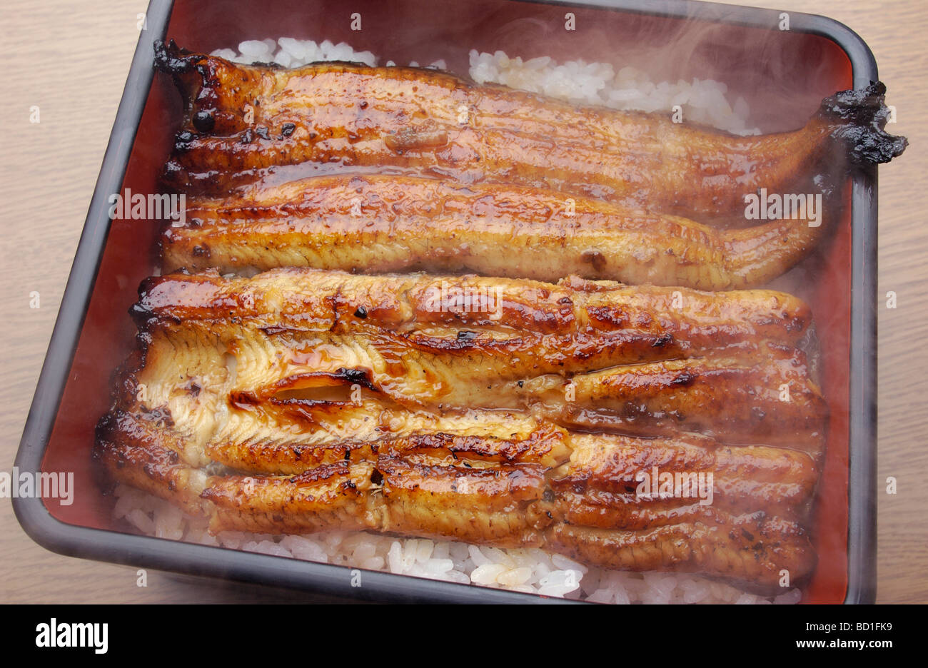 Broiled eel on rice in box close up Stock Photo - Alamy