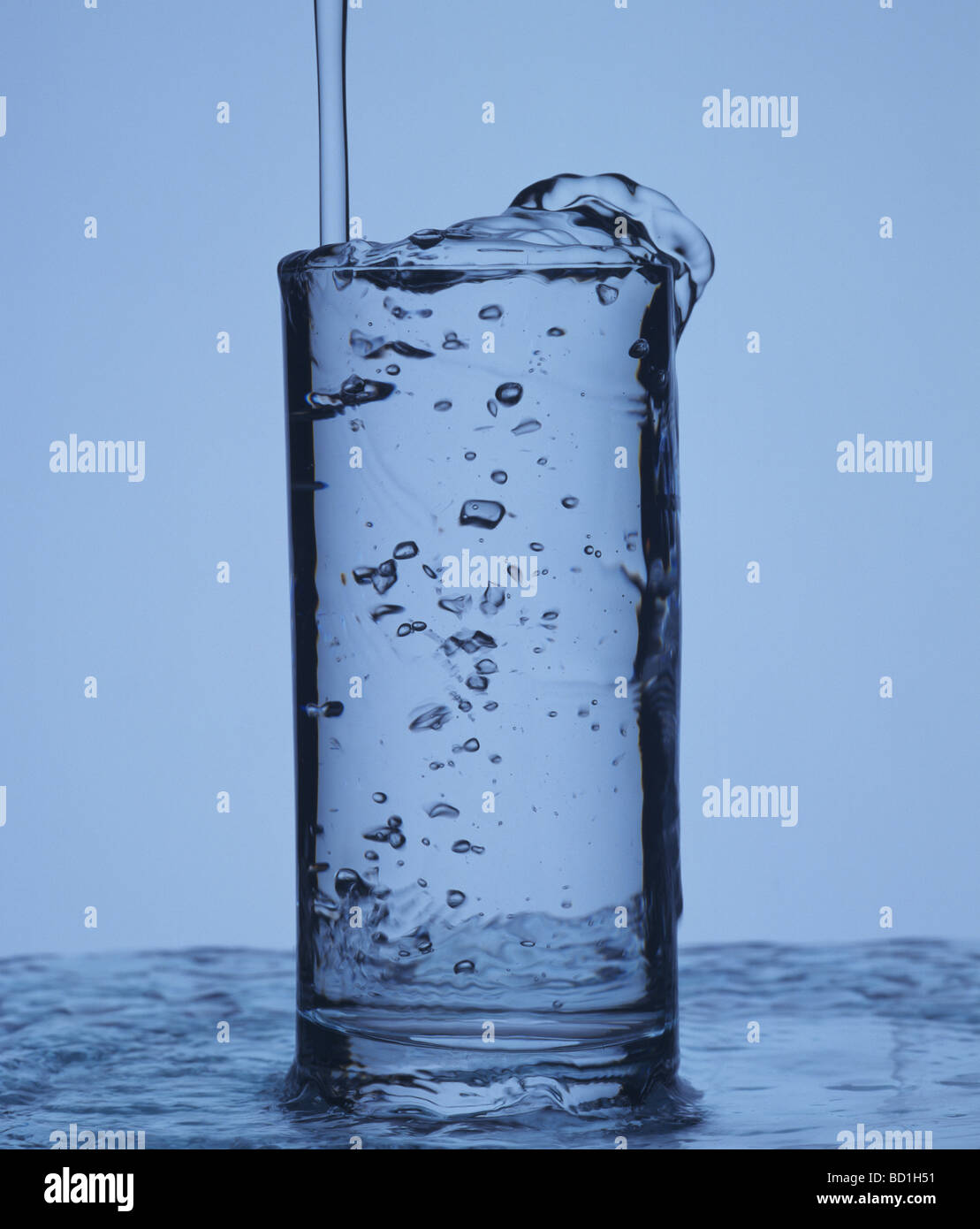 Water overflowing from glass Stock Photo - Alamy