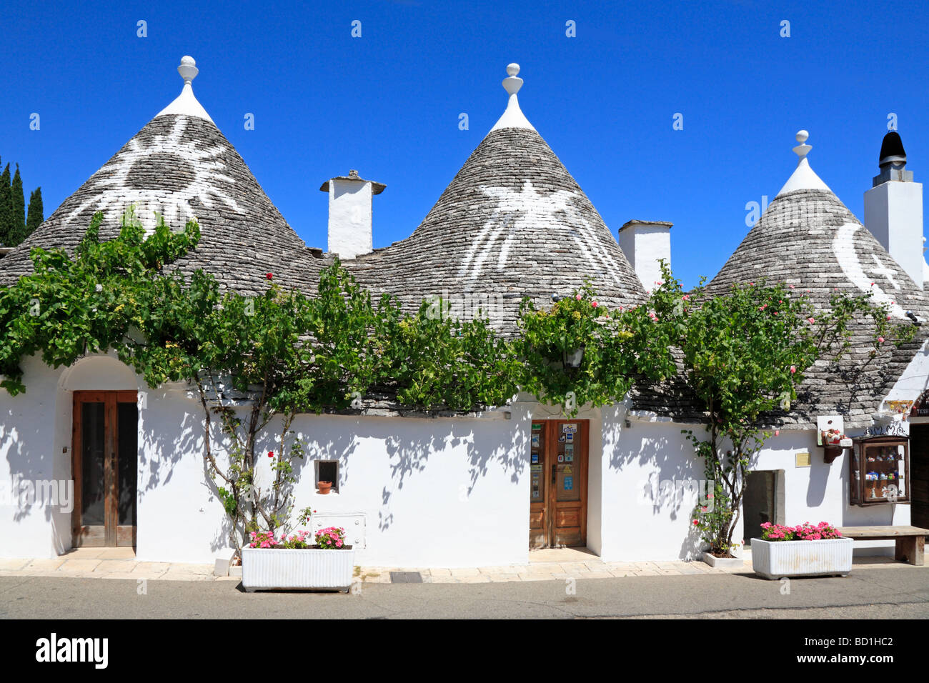 Painted symbols on trulli in Rione Monti, Alberobello, Trulli Village ...