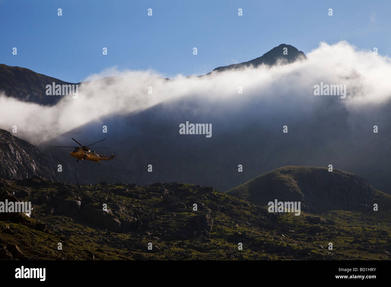 RAF Rescue helicopter flying through low cloud below the summit of ...