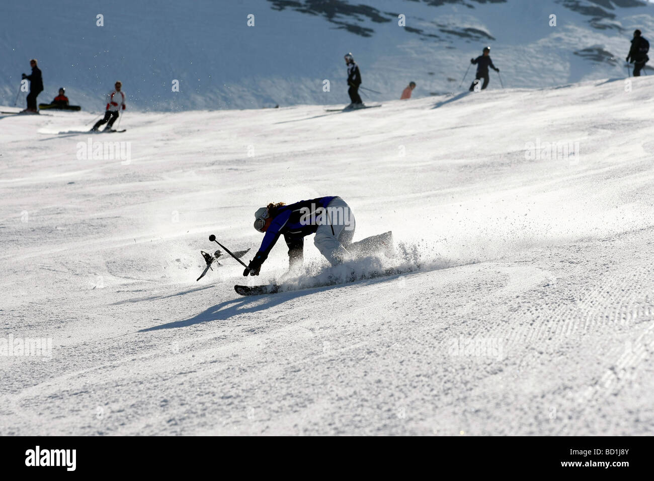 Skier falling down while going downhill in Austria Stock Photo - Alamy