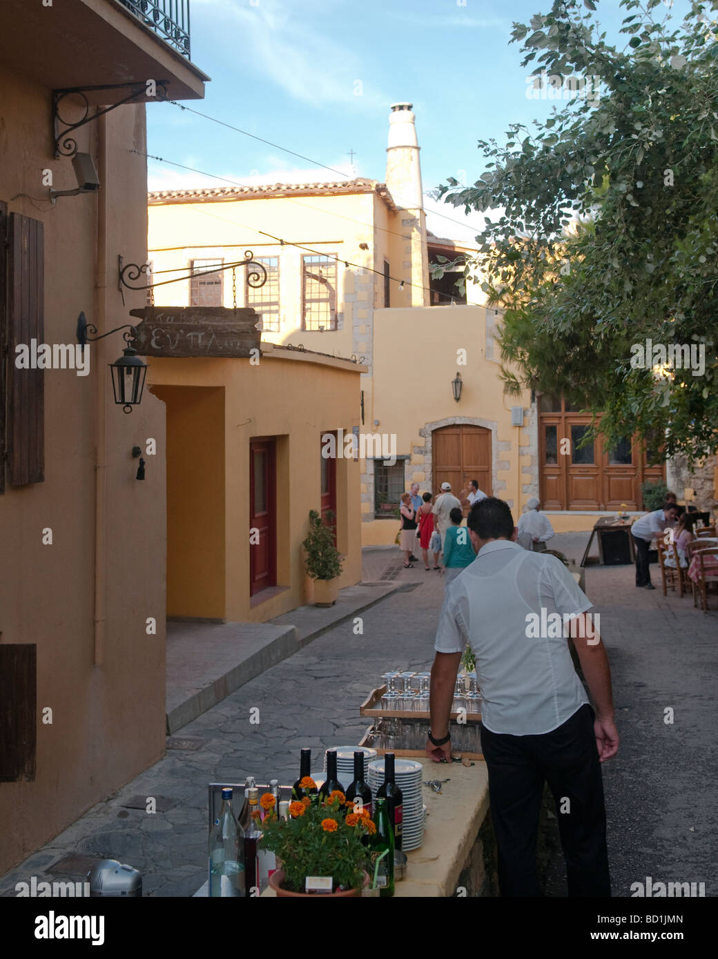 Waiter in outdoor taverna. Chania, Crete, Greece Stock Photo - Alamy