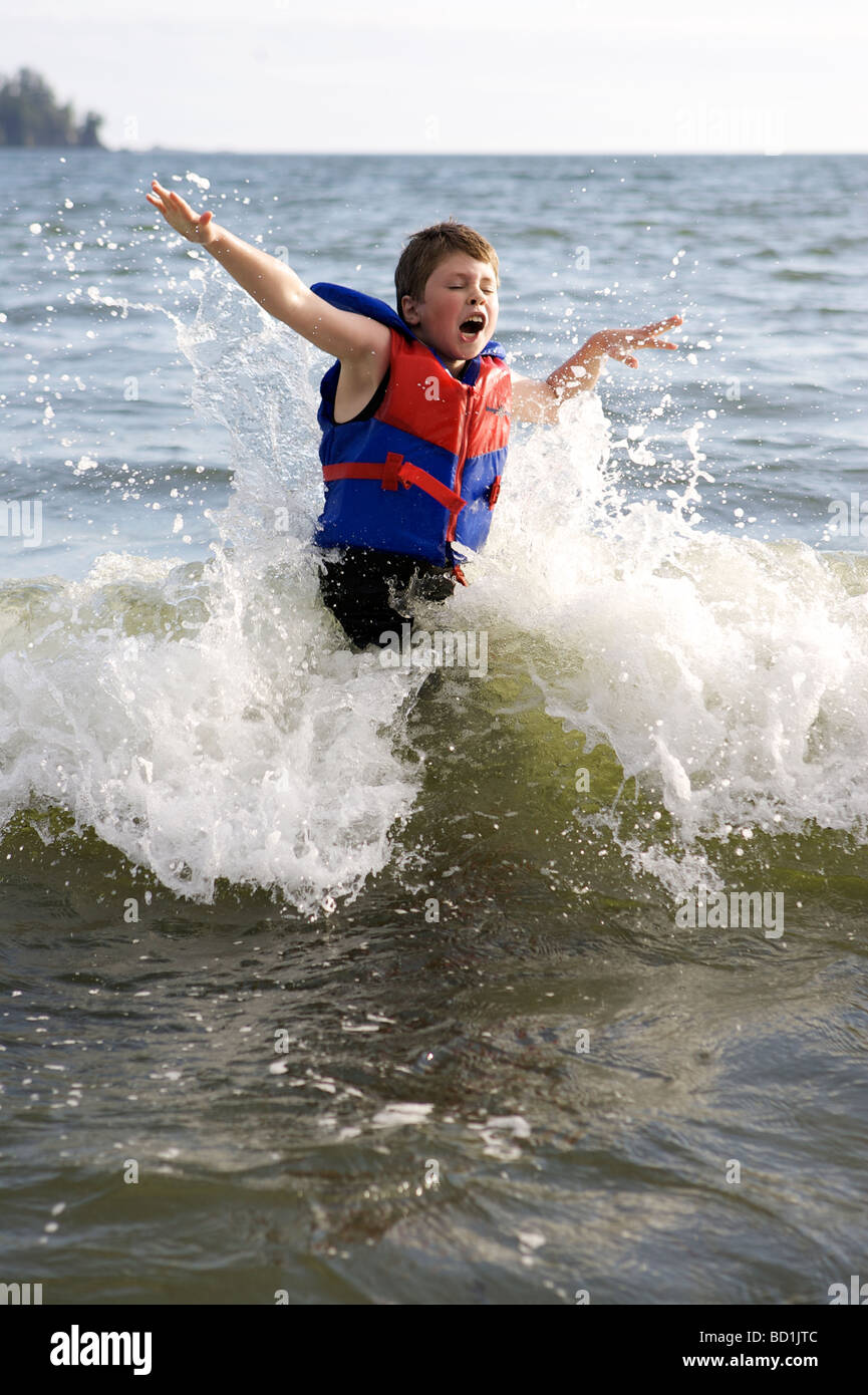 Boy having fun in the ocean Stock Photo - Alamy