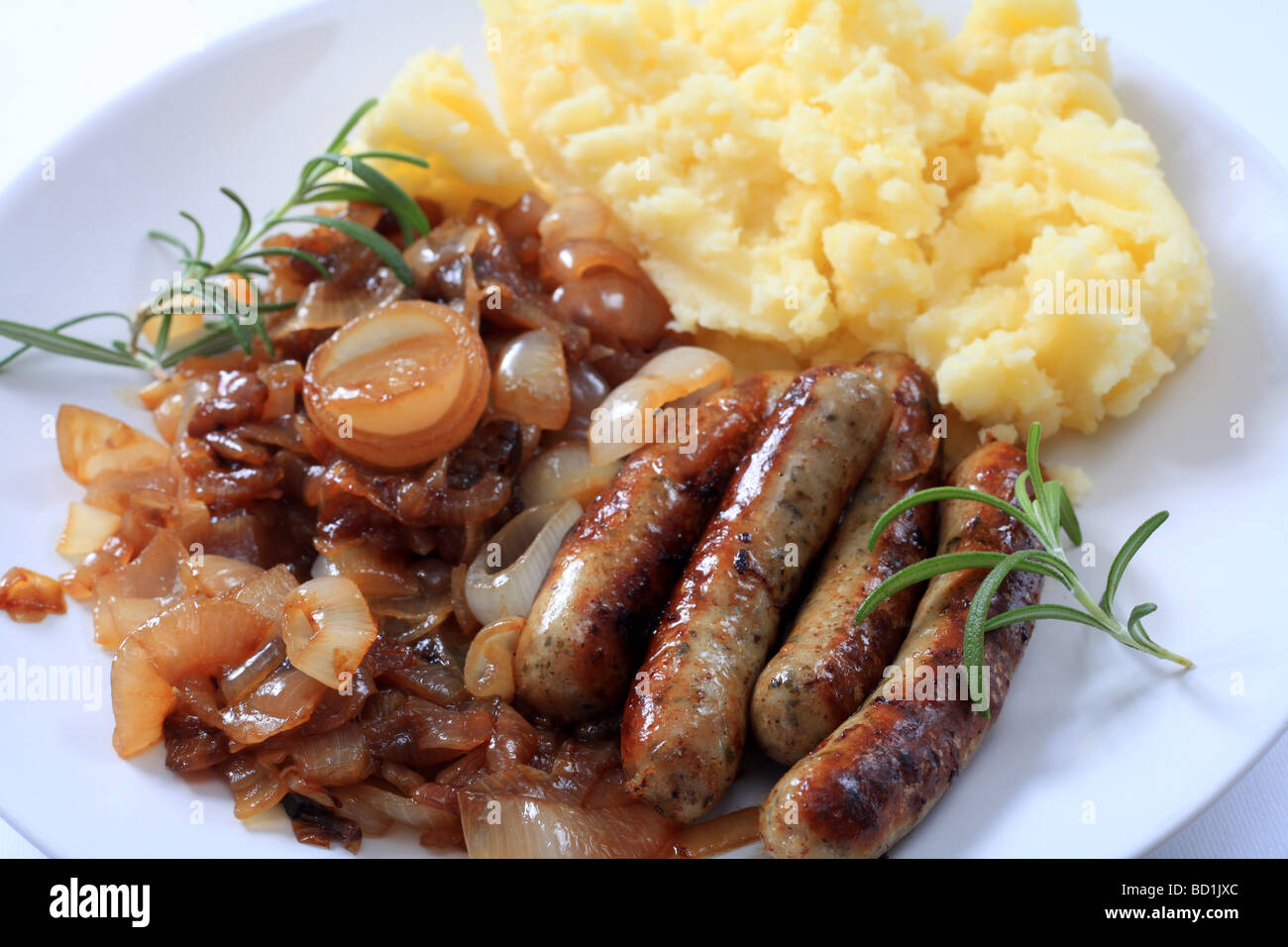Traditional British bangers and mash fried sausages with onions and ...