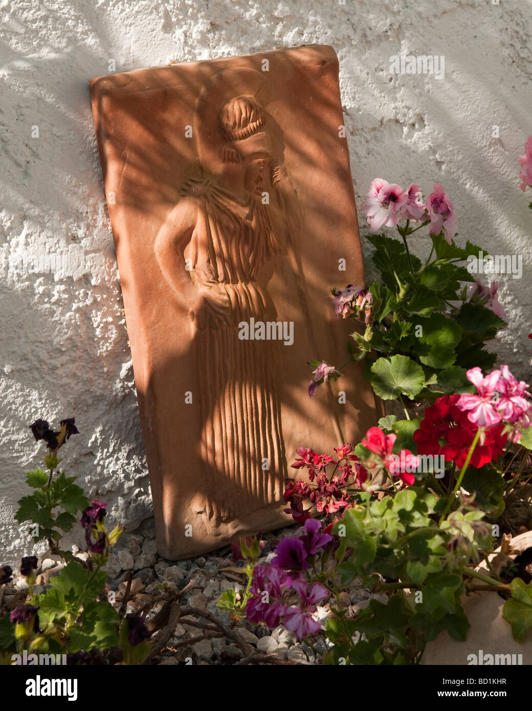 Decorative plaque in garden depicting ancient Greek gardener Stock ...