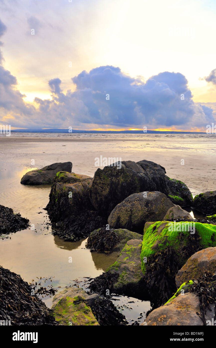 sunset on Enniscrone Beach Co Sligo Ireland with rocks in foreground ...