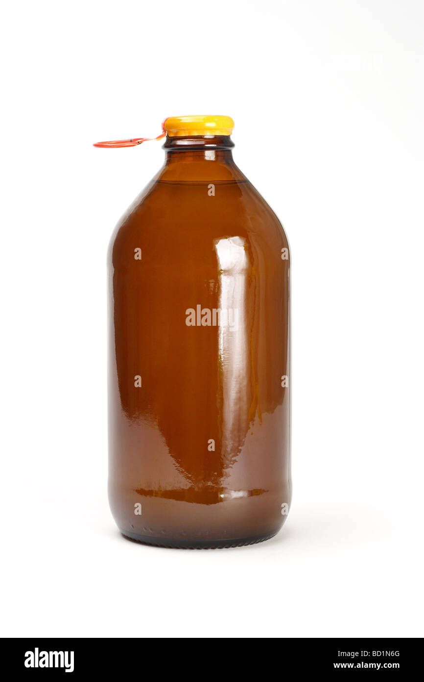 Bottle of fruit juice with yellow metal cap on white background Stock ...