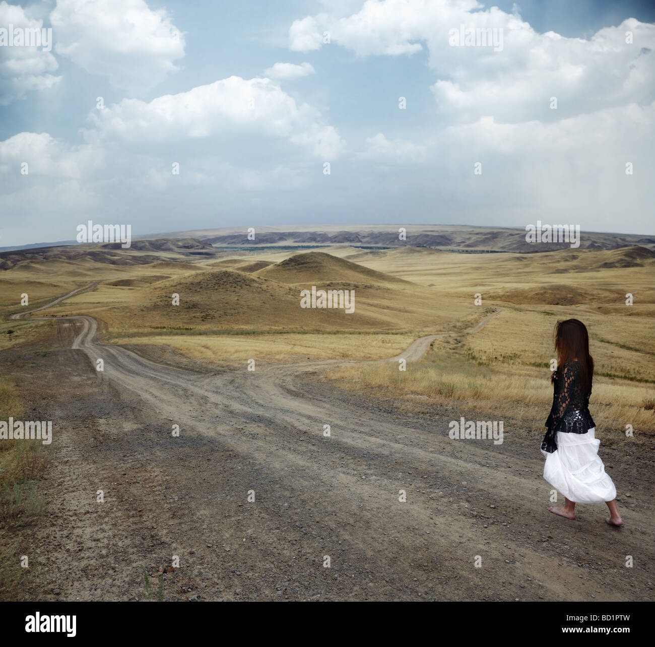 Single woman walking outdoors Stock Photo - Alamy