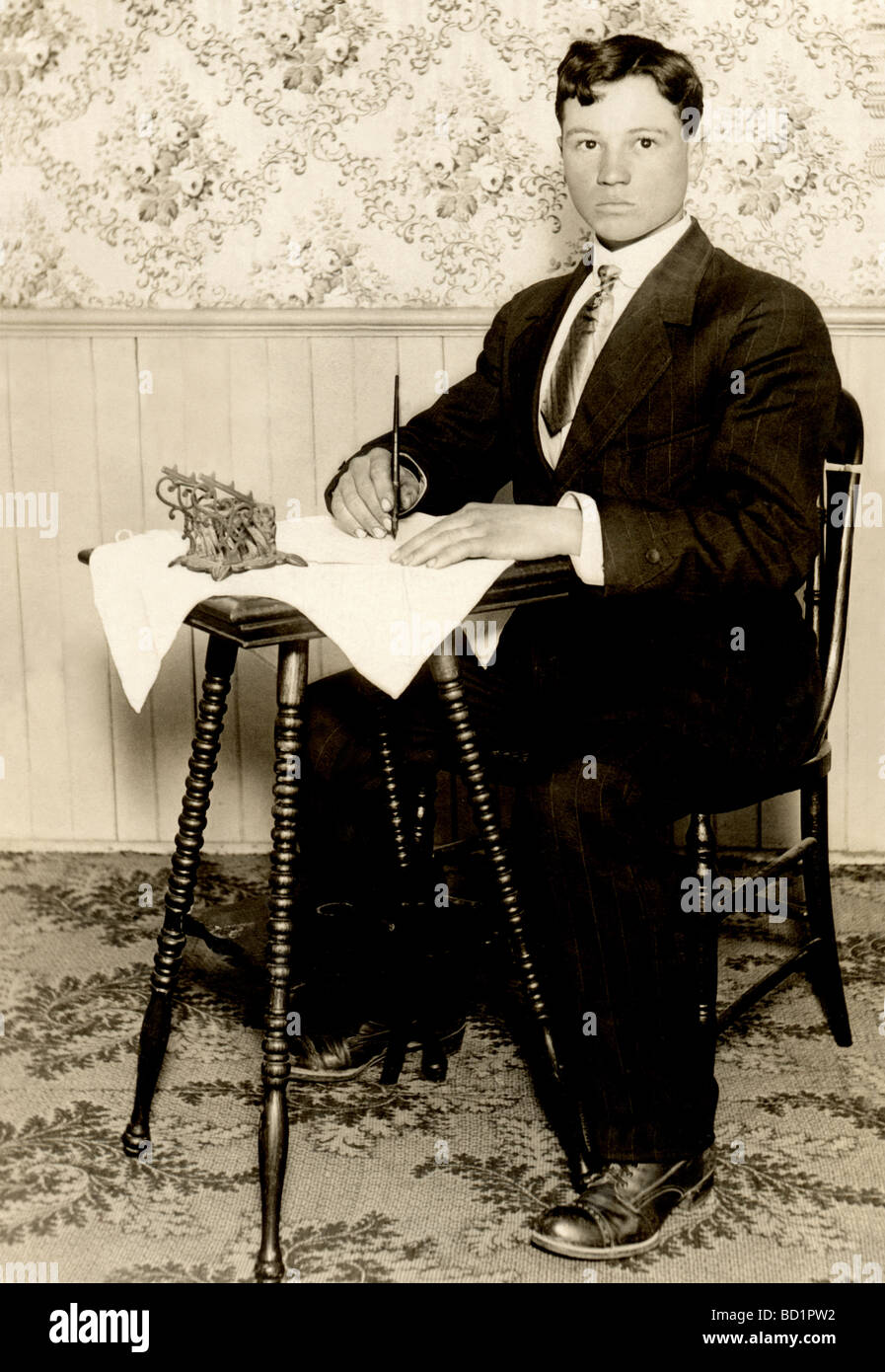 Boy Writing at Table with Quill Pen Stock Photo - Alamy
