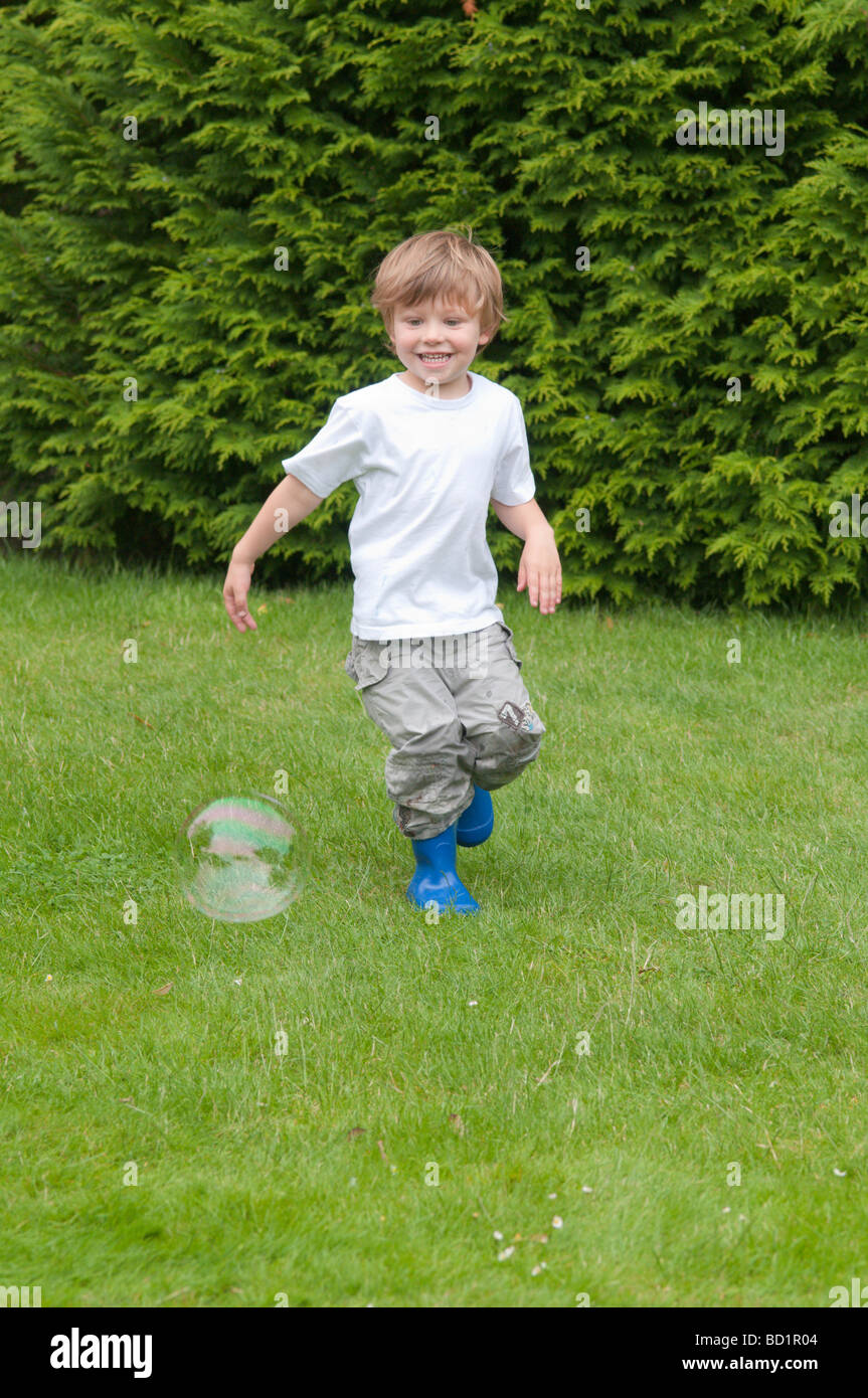 Happy boy chasing bubbles hi-res stock photography and images - Alamy
