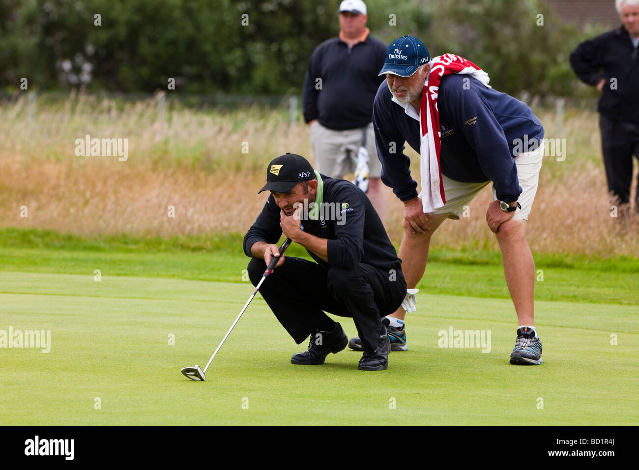 Caddie and golfer lining up putt hi-res stock photography and images - Alamy