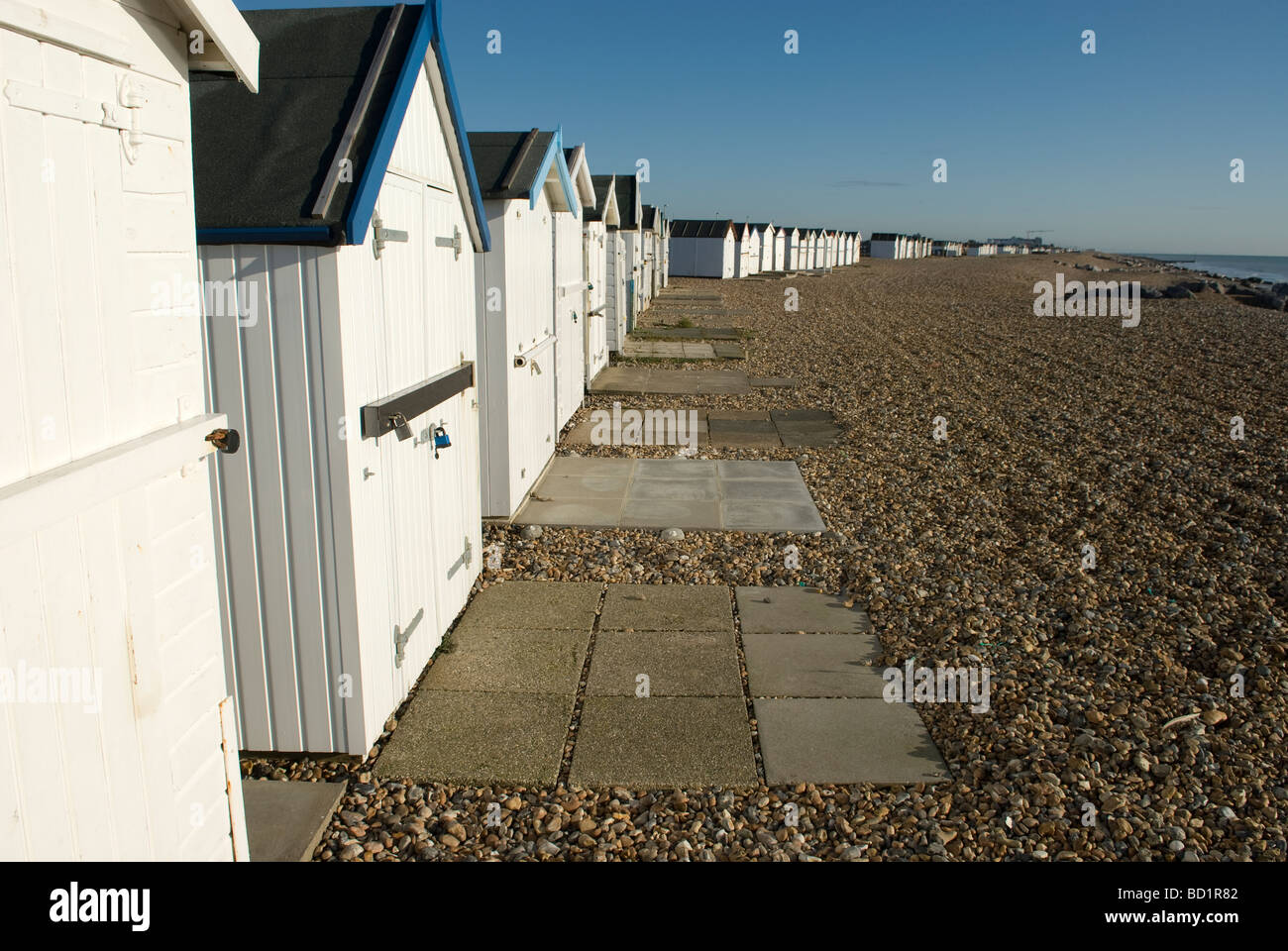 deserted beach huts at Worthing beach Stock Photo - Alamy