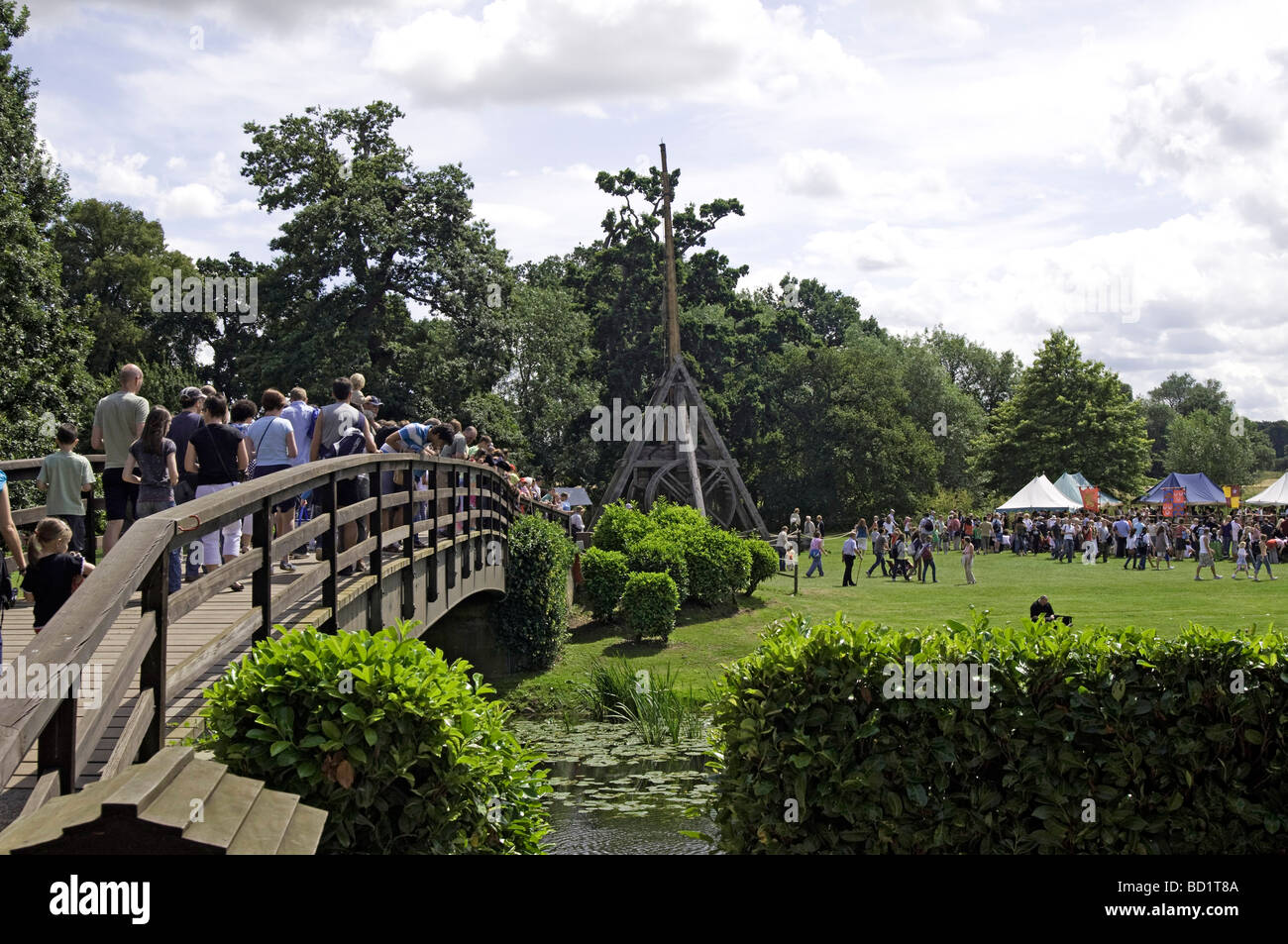 Visitors crossing the wooden bridge to view the jousting tournament at ...