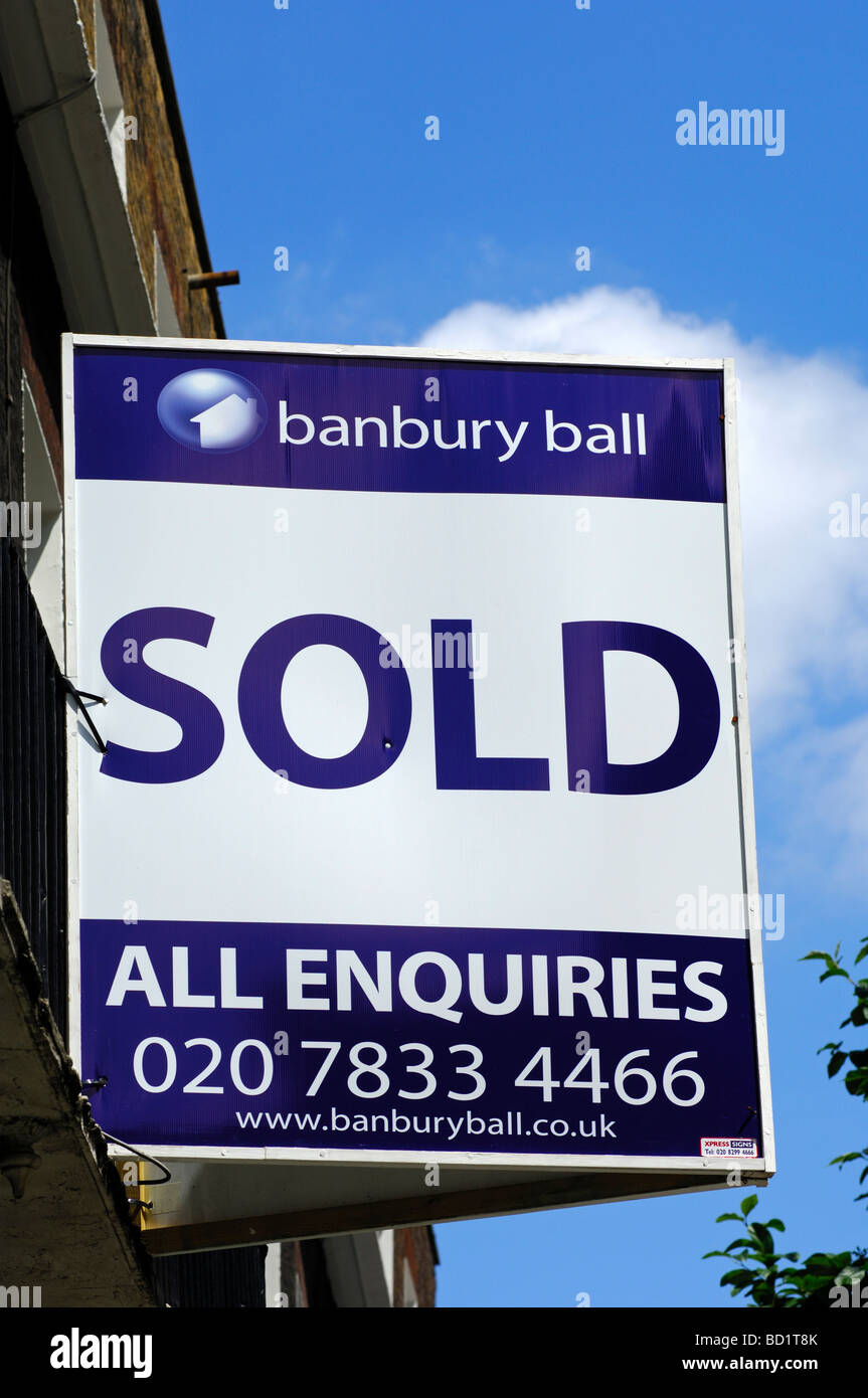 Sold signs of the Banbury Ball estate agents at a building, London ...